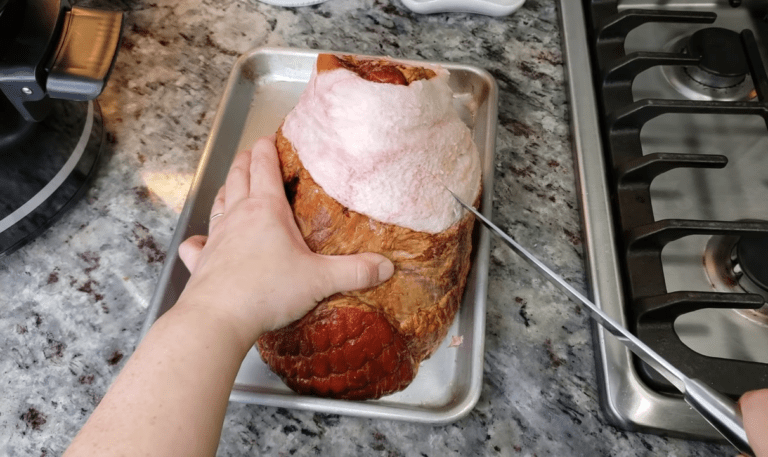 Dump a ham into a crockpot. Add pineapple juice and brown sugar for the ...