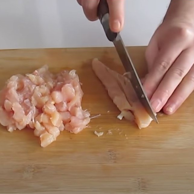 Chef piles chicken and veggie mixture on top of pastry dough for hearty ...