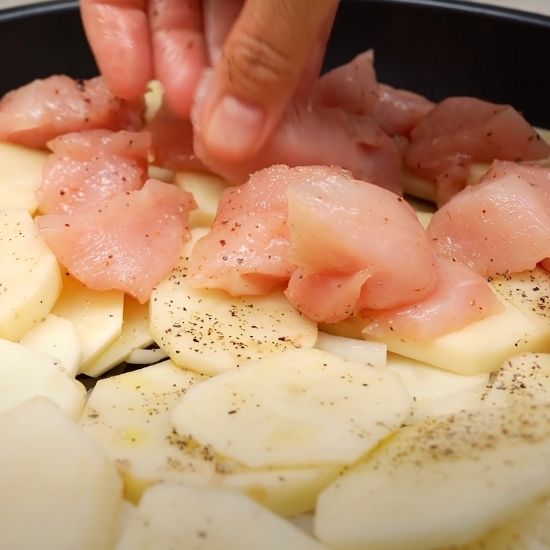 Pours beaten eggs over chicken and potatoes for tasty one-pan dinner