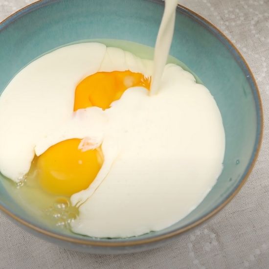 Pours beaten eggs over chicken and potatoes for tasty one-pan dinner