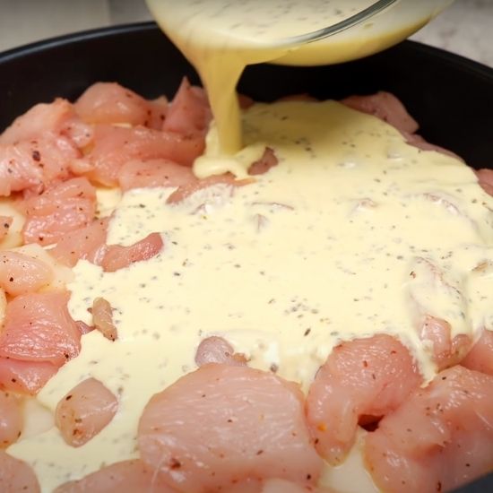 Pours beaten eggs over chicken and potatoes for tasty one-pan dinner