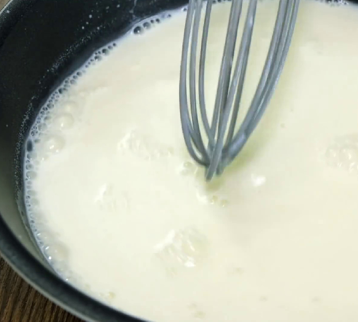 Mom dumps creamy mixture over top of cookies for a delicious dessert ...