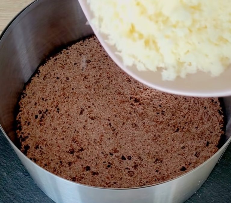 Woman layers chocolate cake with thick coconut filling for delicious ...