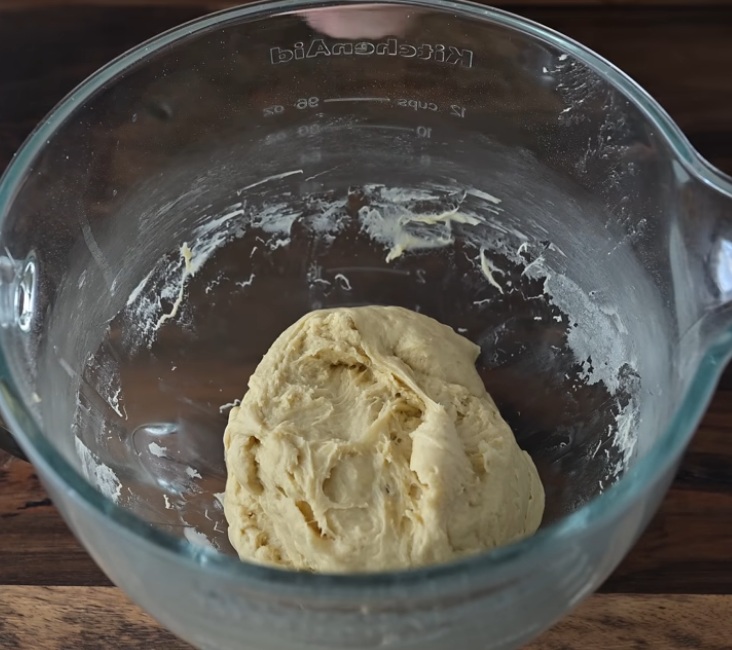 Add cheese and ham between sheets of buttered dough and top with egg ...