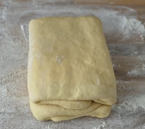 Add cheese and ham between sheets of buttered dough and top with egg ...