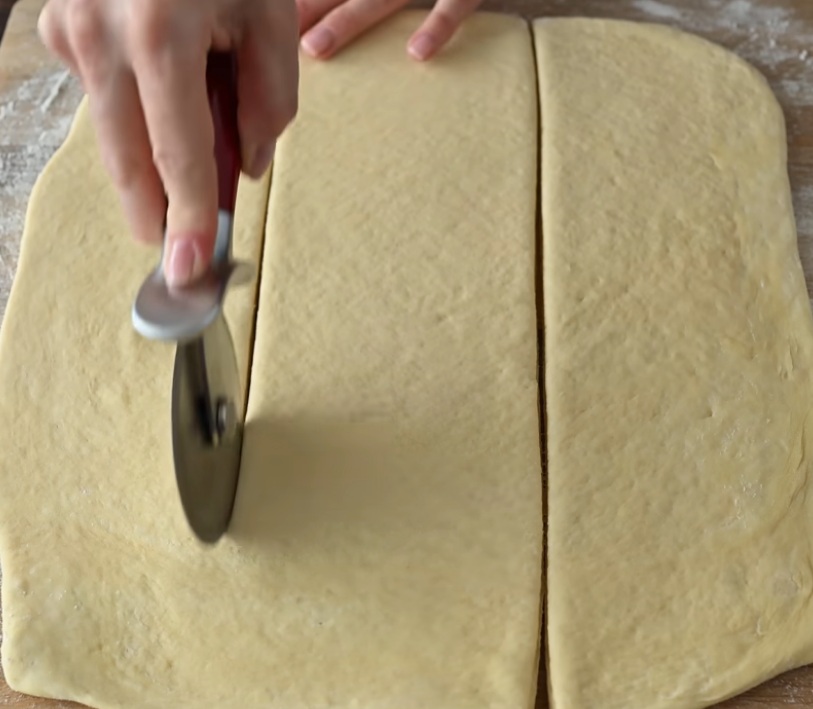 Add cheese and ham between sheets of buttered dough and top with egg ...